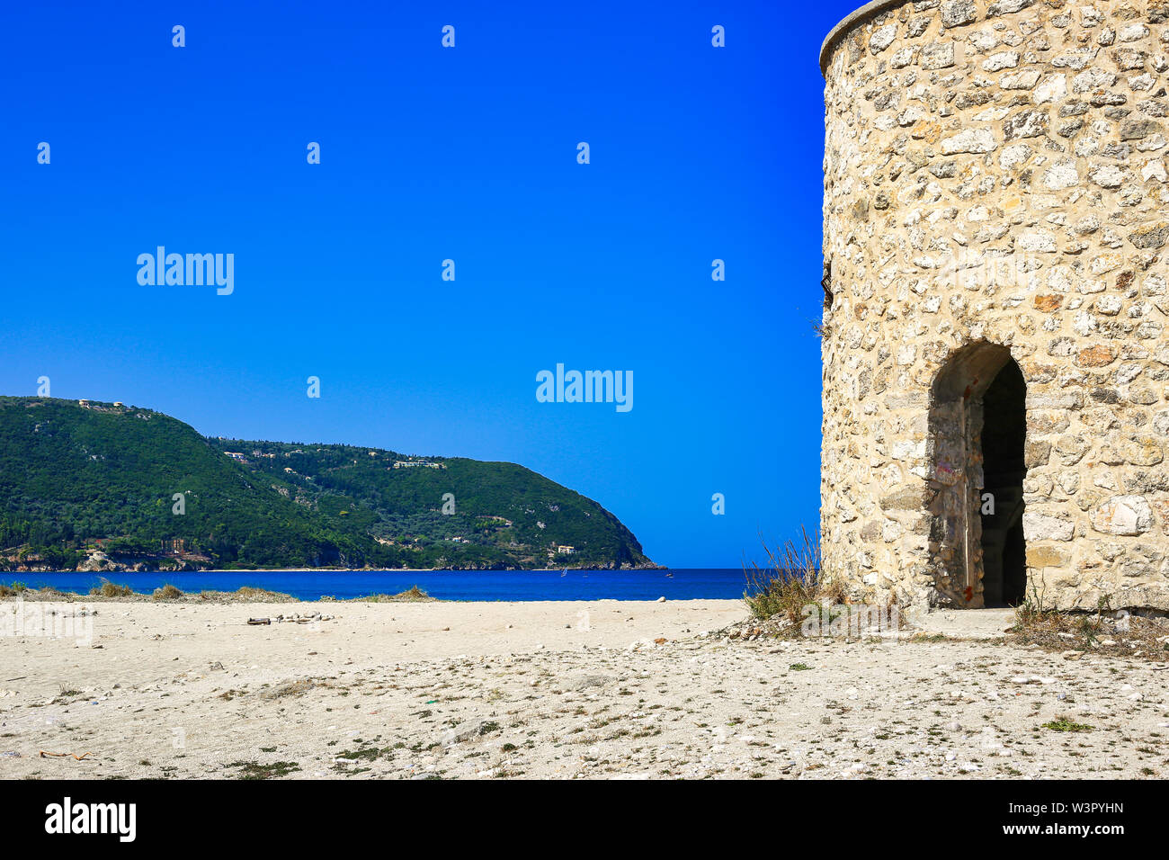 Beautiful seascape with old windmill on Agios Ioannis (Gyra) beach ...