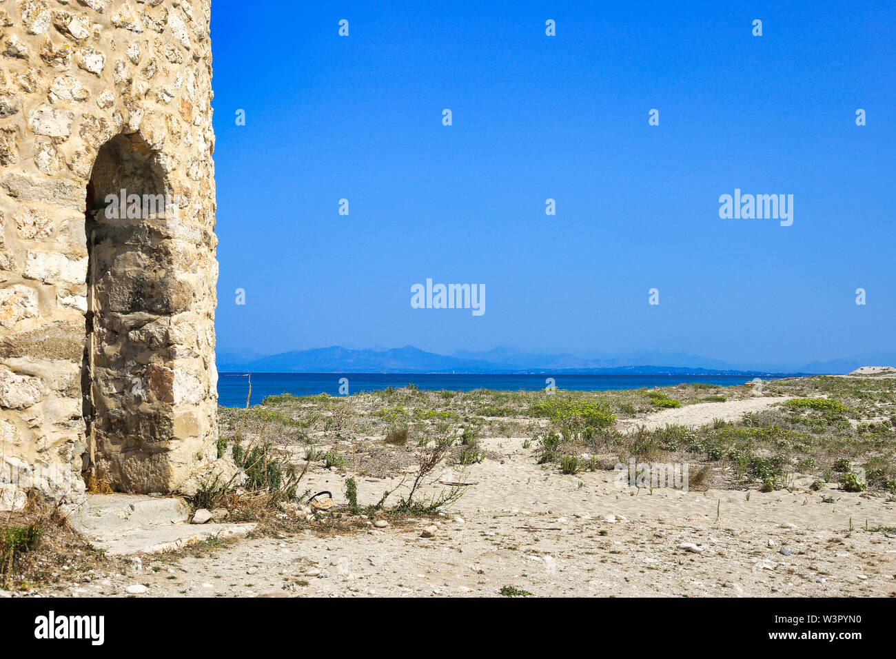Beautiful seascape with old windmill on Agios Ioannis (Gyra) beach ...