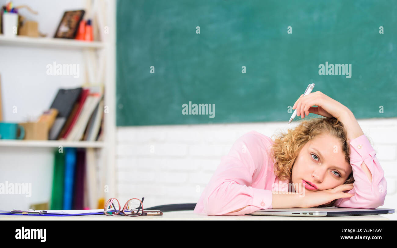 Woman tired in school classroom. Teacher exhausted after hard working ...