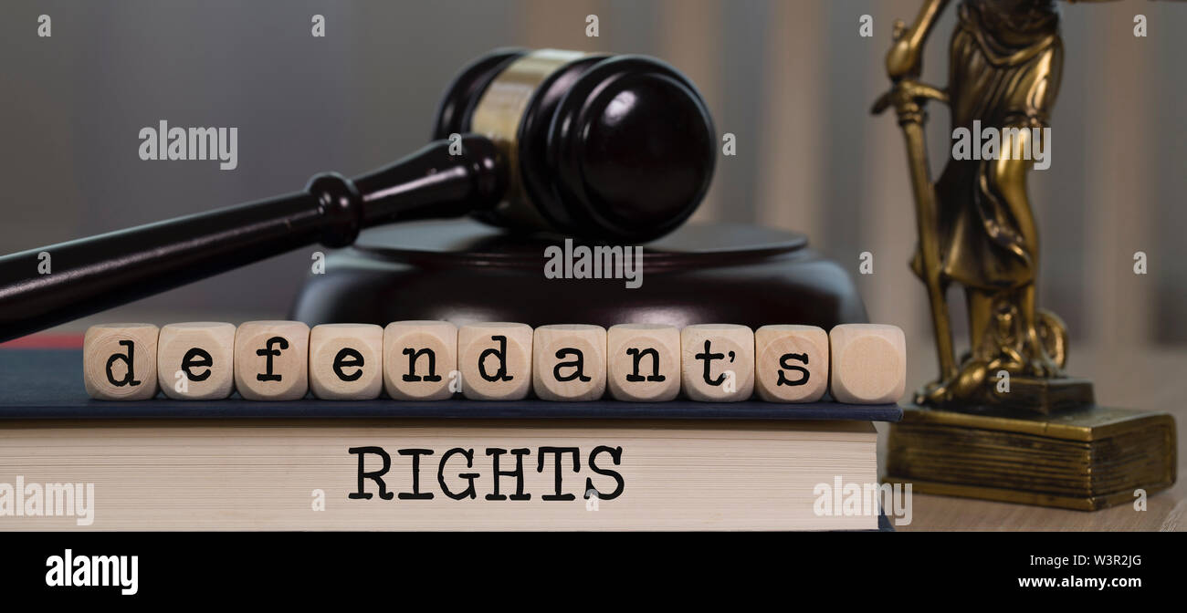 Words DEFENDANT'S RIGHTS composed of wooden dices. Wooden gavel and ...