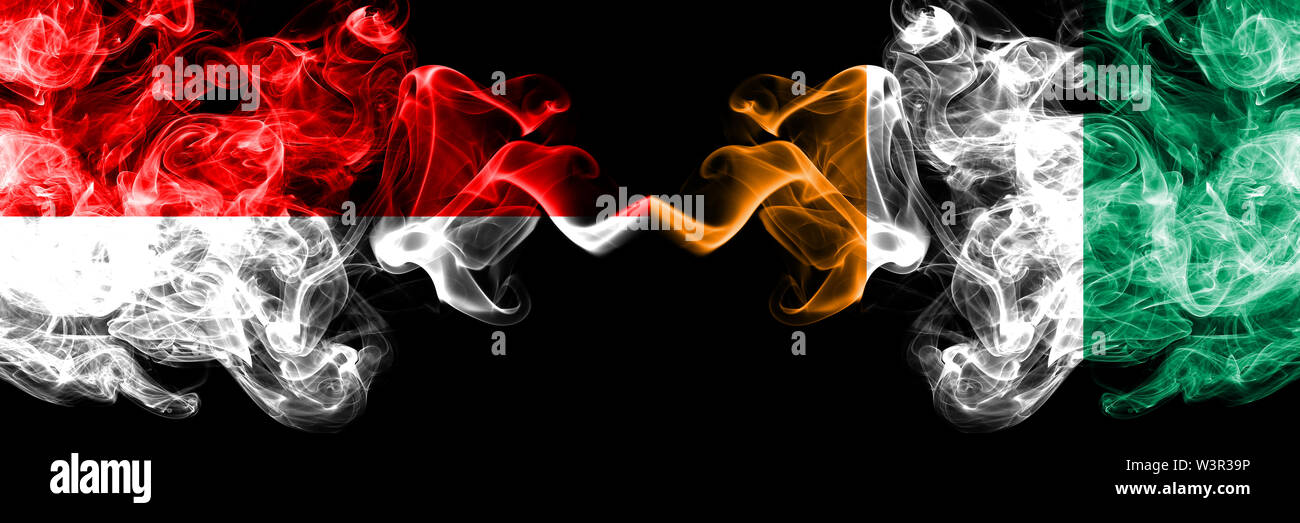 Indonesia vs Ivory Coast smoky mystic flags placed side by side. Thick ...