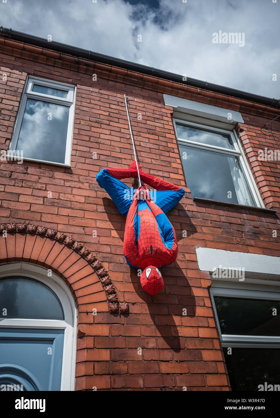 Spiderman scarecrow hanging from a Victorian terraced house in a ...