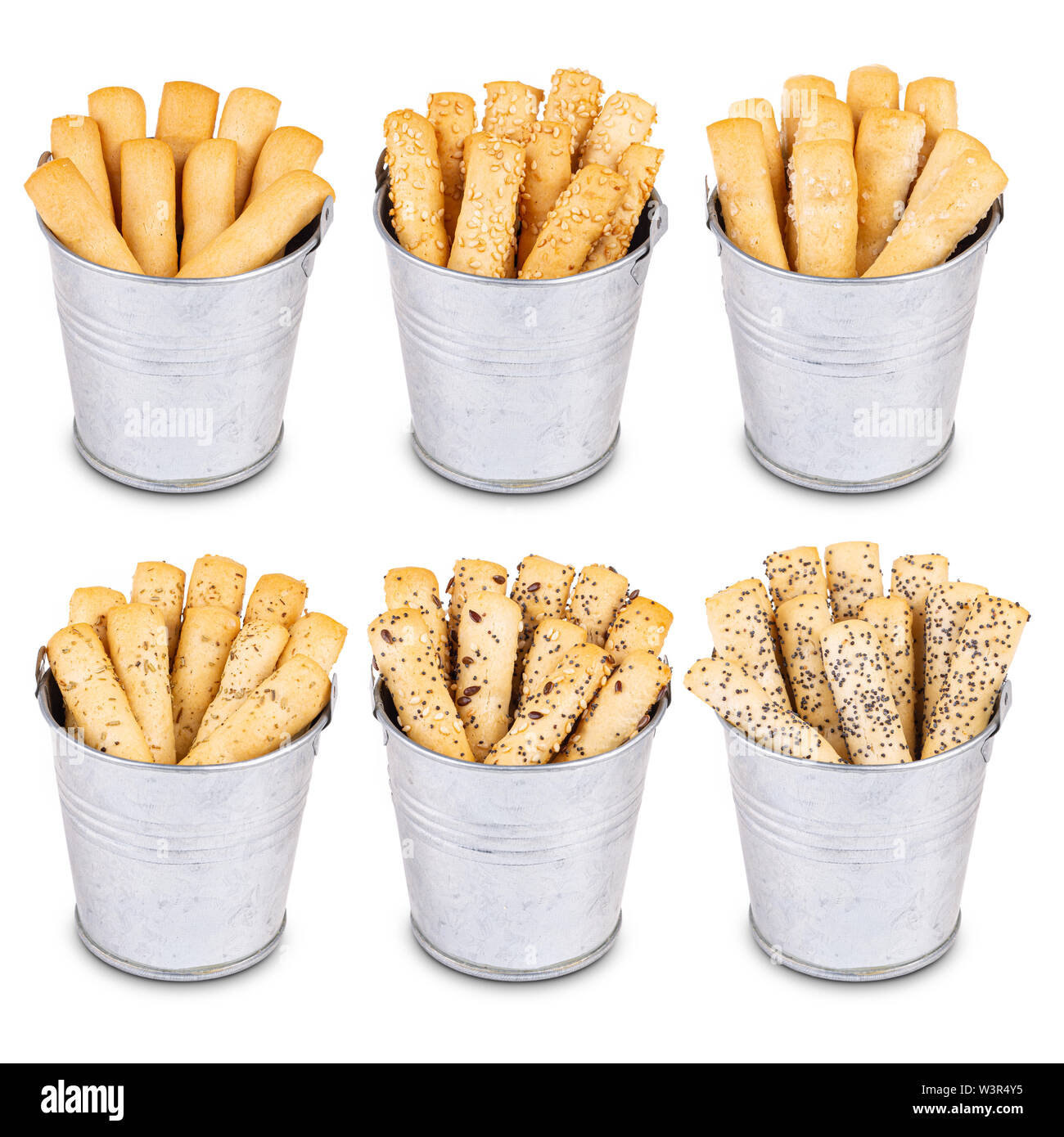 Different kind of crispy bread sticks in metal bowl on white background ...