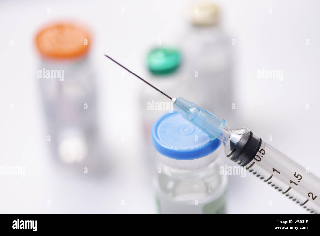 Medicine bottles glass and syringe injection needle on white background ...