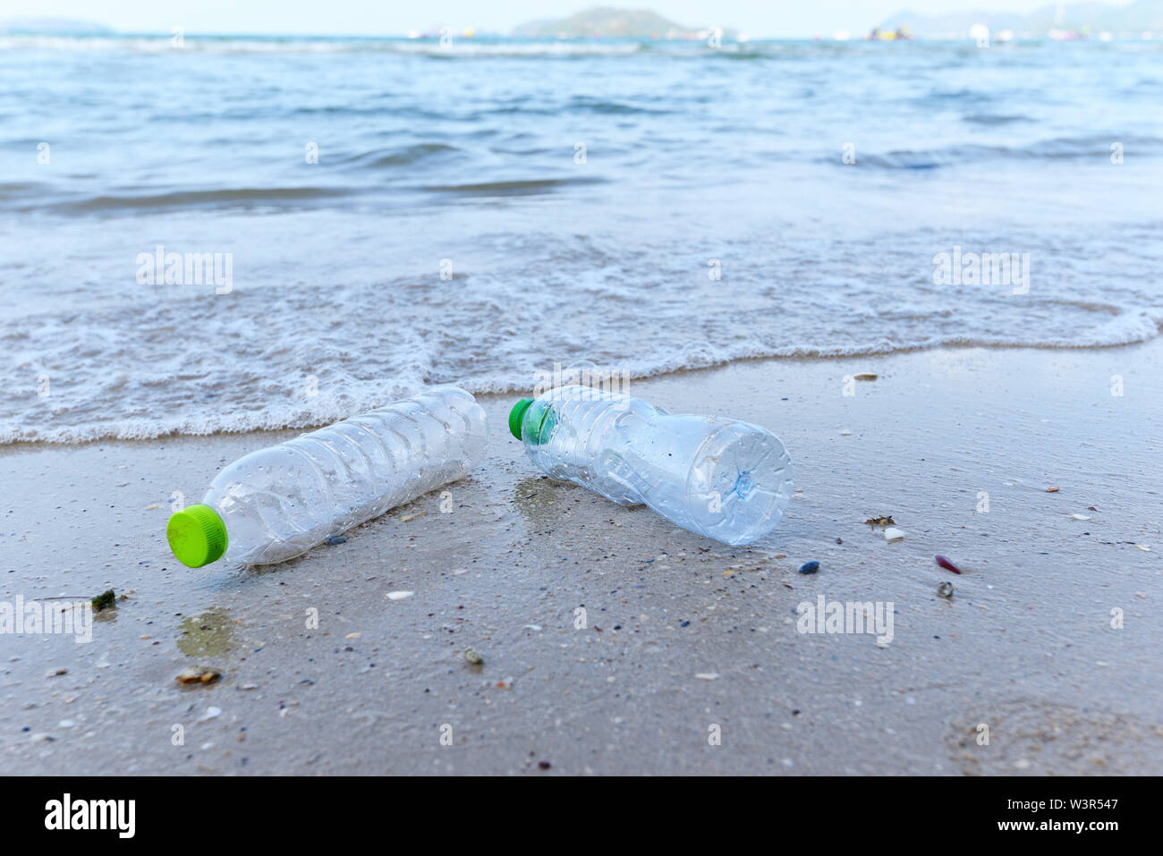 Garbage in the sea with plastic bottle on beach sandy dirty sea on the ...