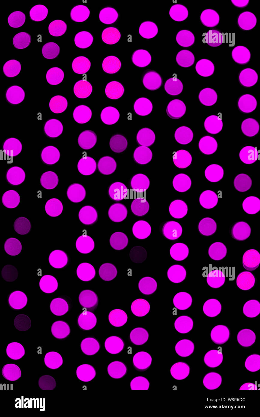 Unfocused abstract purple bokeh on black background. defocused and ...