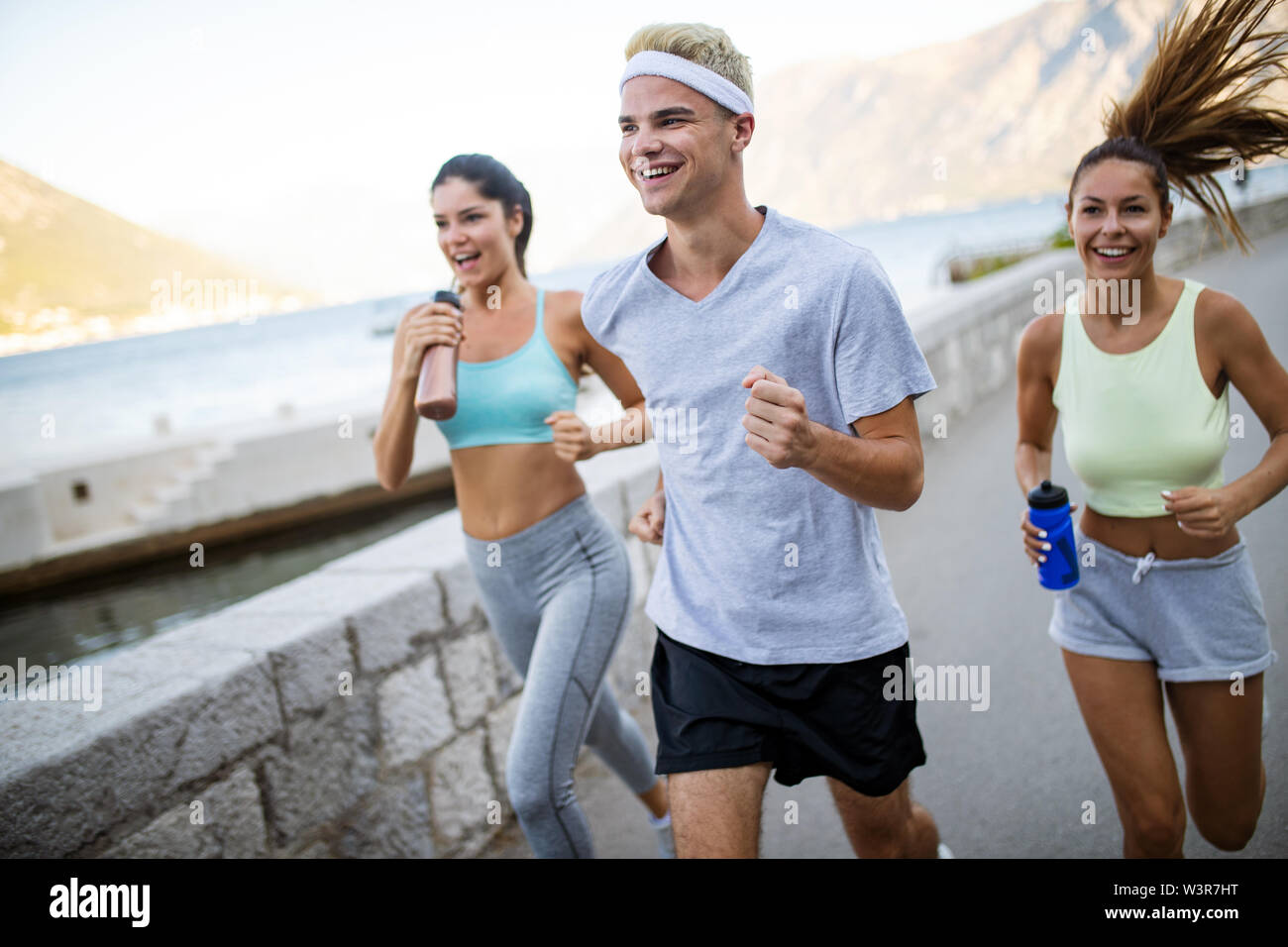 Friends fitness training together outdoors living active healthy Stock ...
