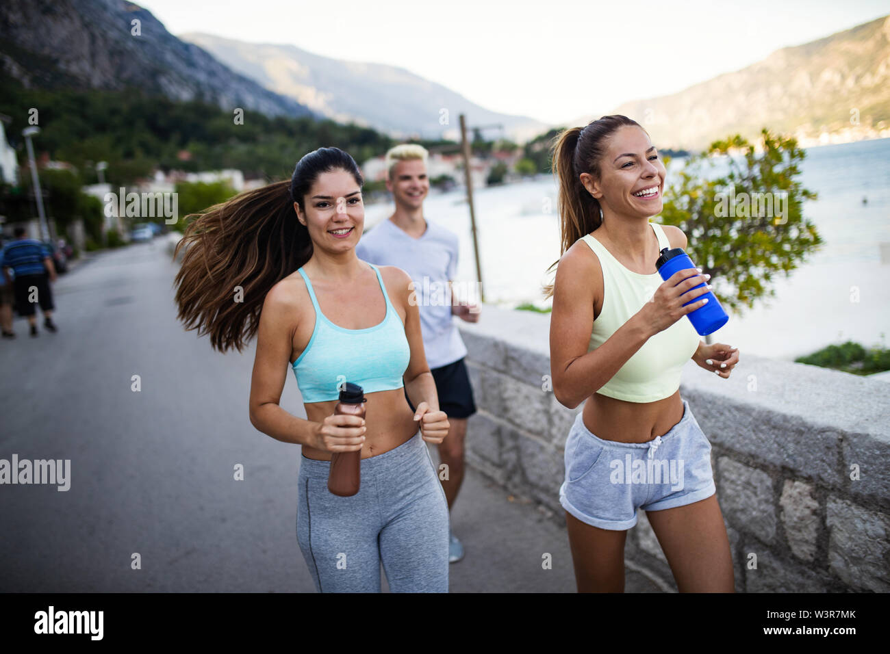 Group of young people friends running outdoors at seaside Stock Photo ...