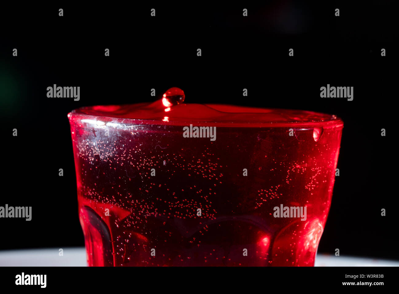 drops of red liquid in glass beaker Stock Photo - Alamy