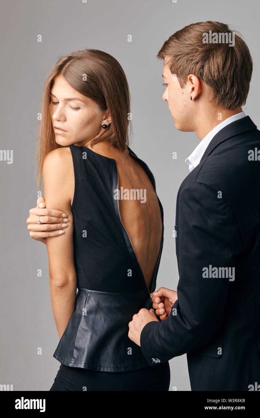 Man zipping up girlfriend's dress. man helping woman zip up dress ...