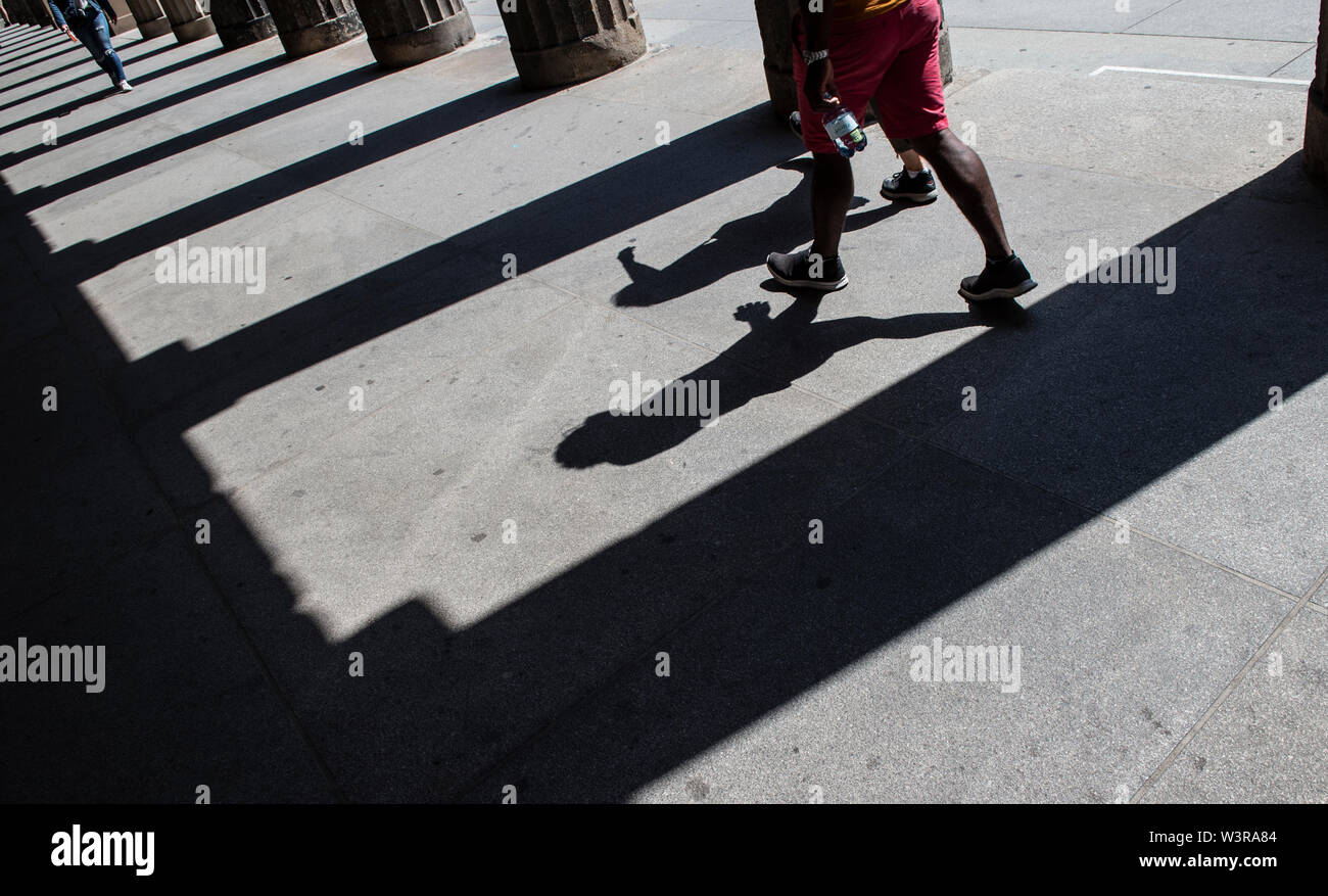 Berlin, Germany. 17th July, 2019. Passers-by walk in a colonnade on the ...