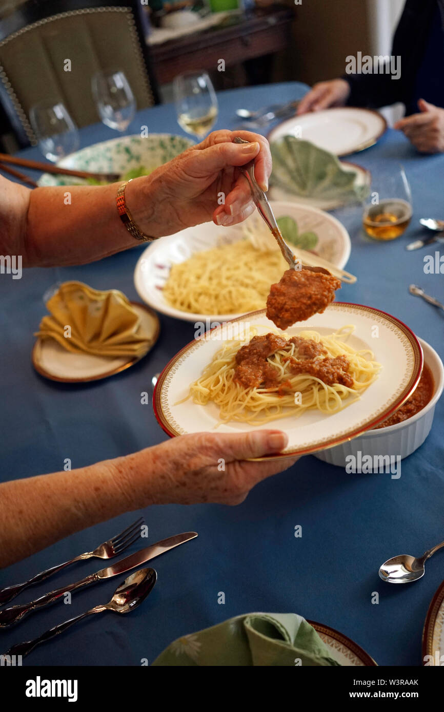 Mature Women is cooking a Italian Spaghetti Dinner in her home kitchen ...