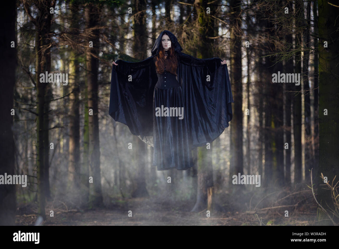 Witch levitating in the forest Stock Photo - Alamy