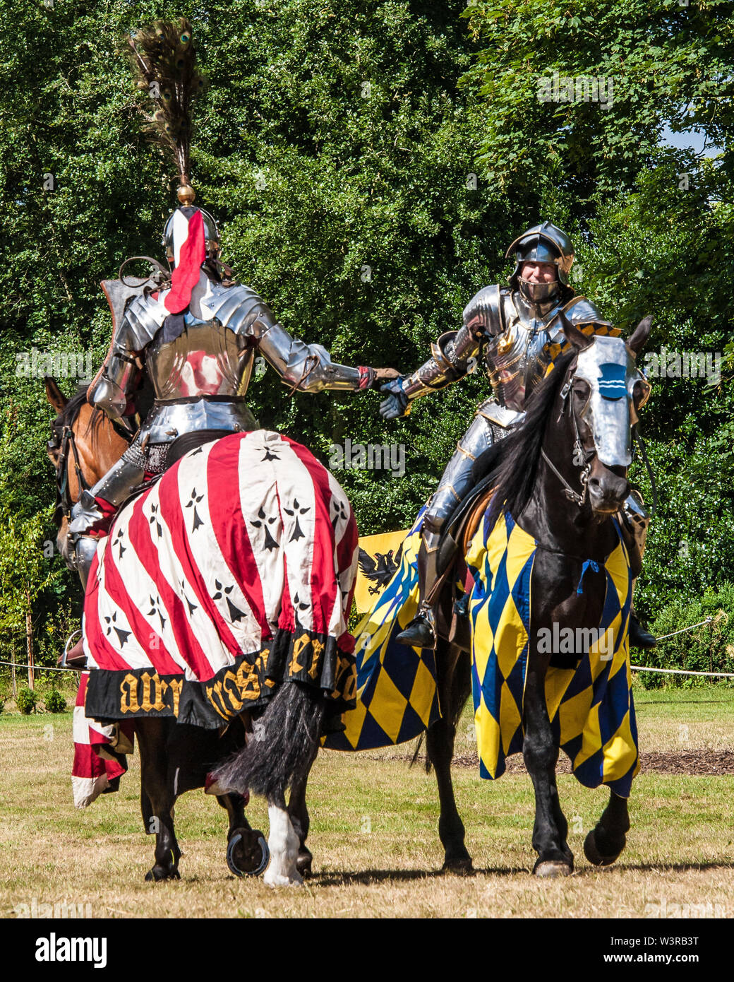 Armoured knights on their horses exchange a handshake during a ...