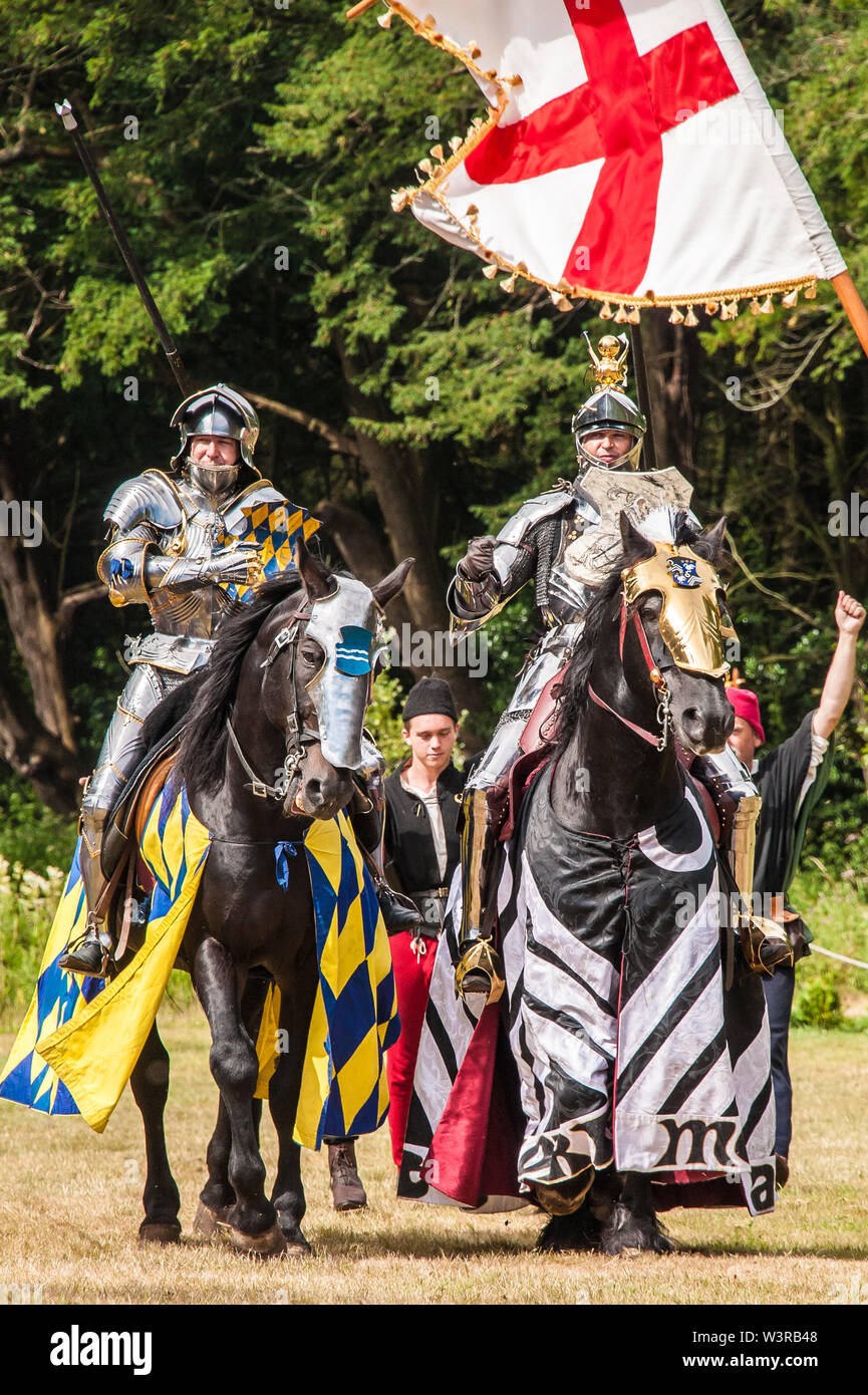Flags flying, armoured knights on their horses enter the arena during a ...