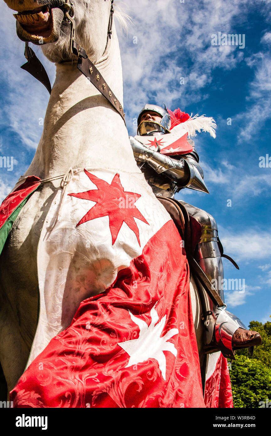 An armoured knight on his charger seen from below during Joust Week at ...