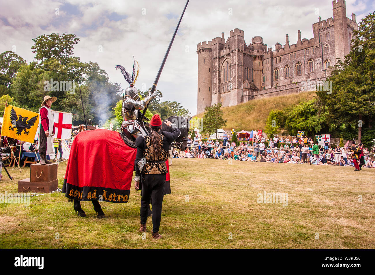 Below the castle a knight on his horse prepares to enter the list at a ...