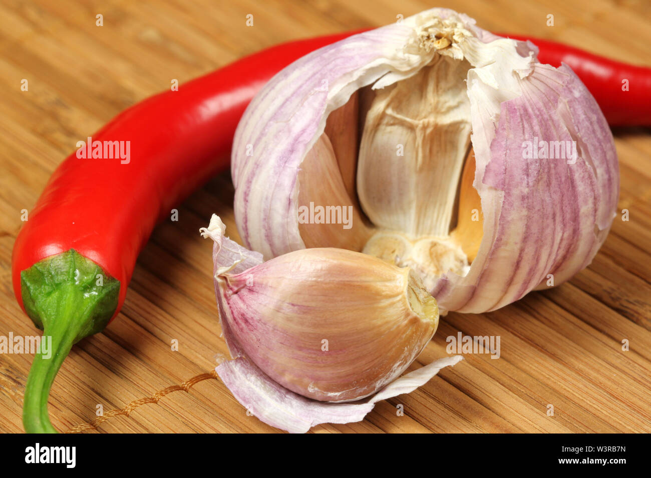 Garlic head and chili pepper pod. Fresh spices Stock Photo - Alamy