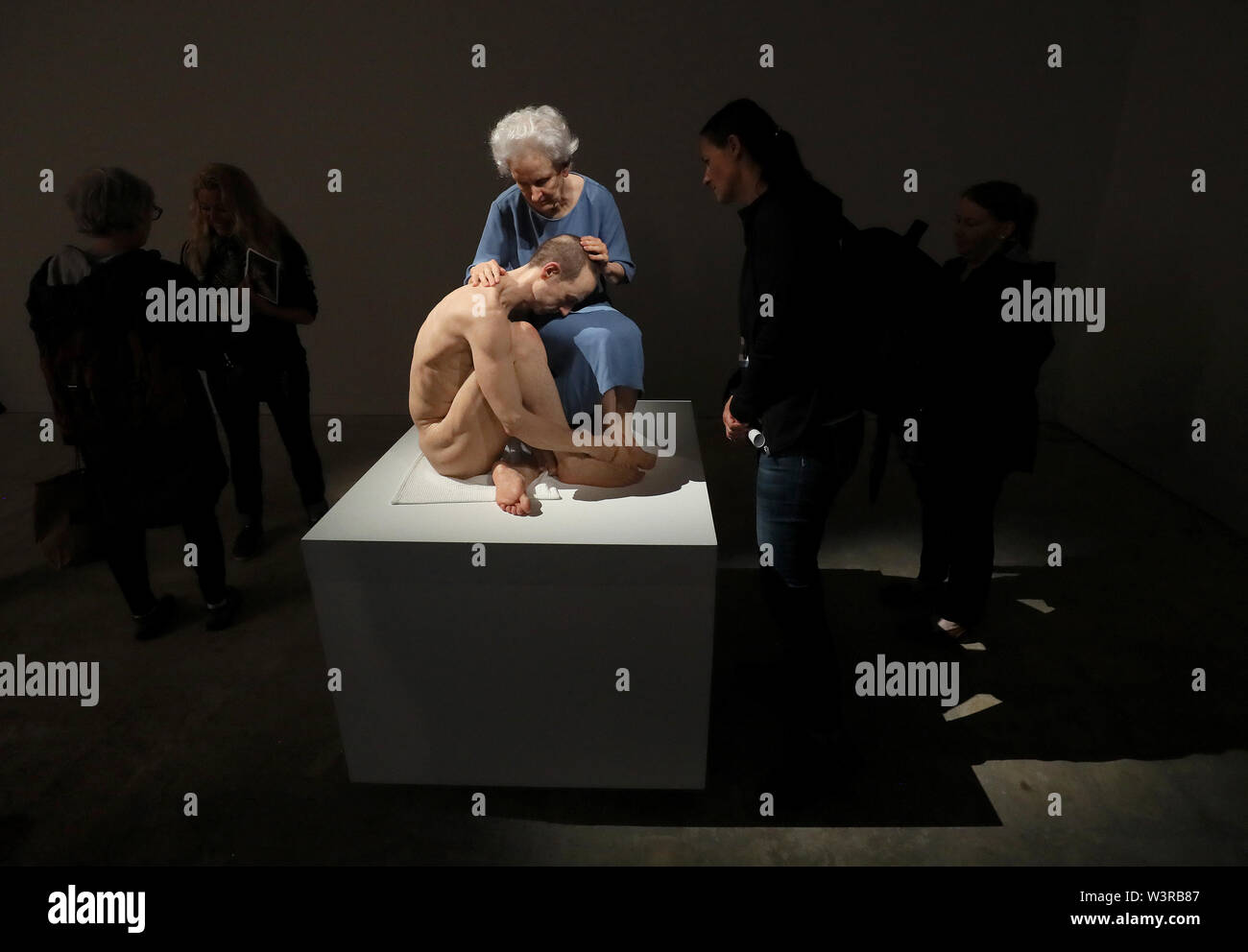 People view Deposition, a lifelike figure by Sam Jinks which forms part ...