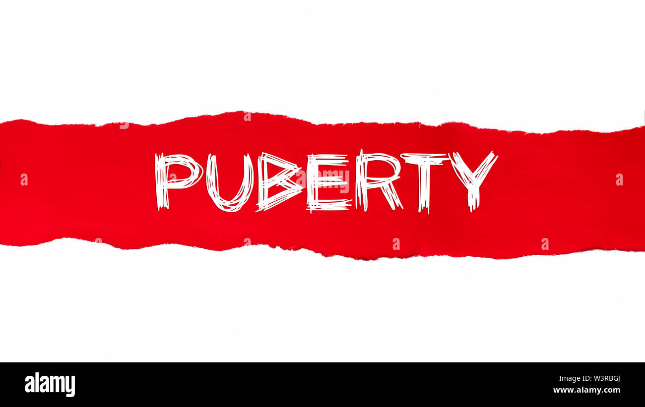 The text PUBERTY written under the curled piece of Red torn paper Stock ...