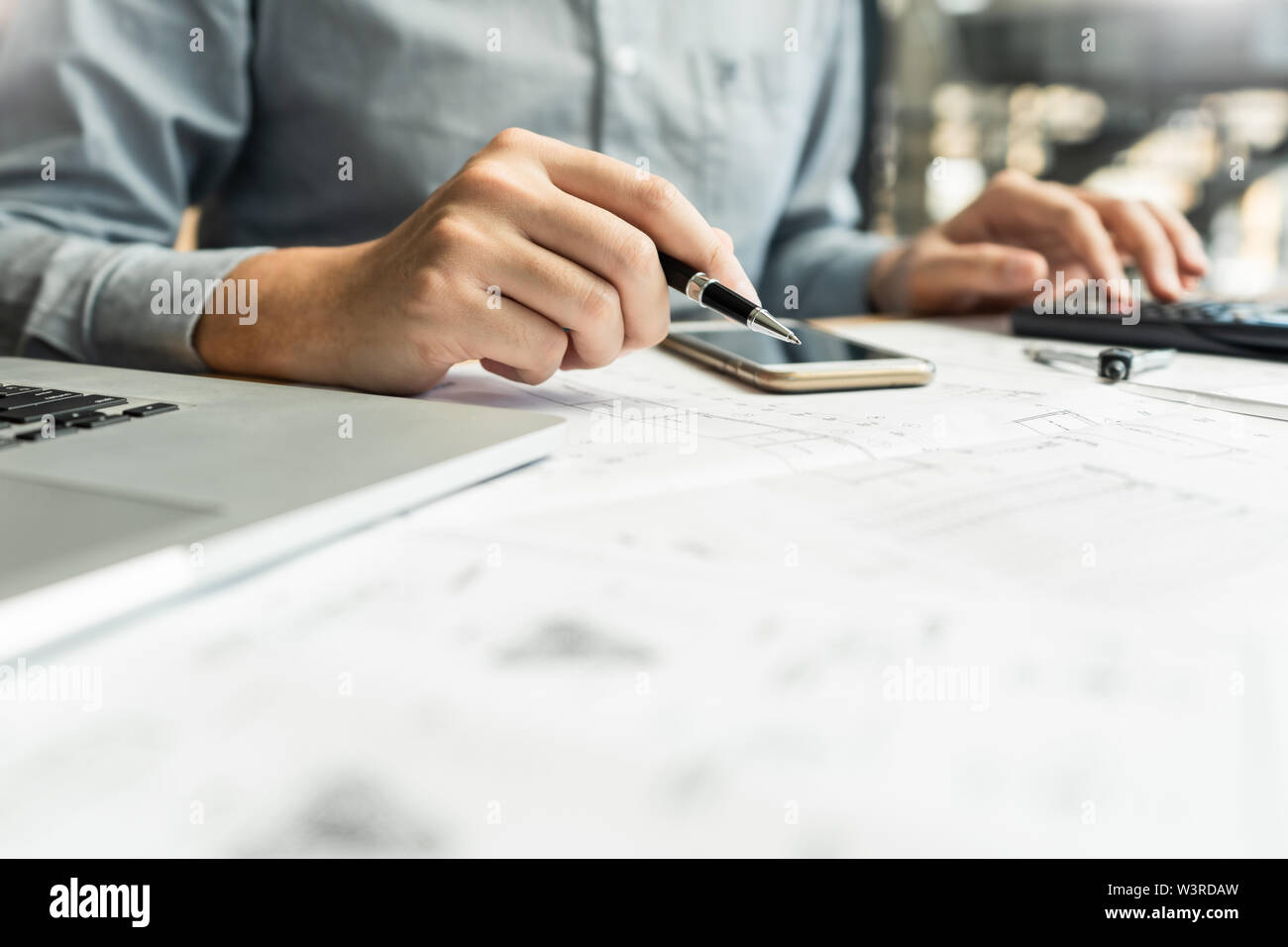 engineer drawing a blue print approve design building with architect ...