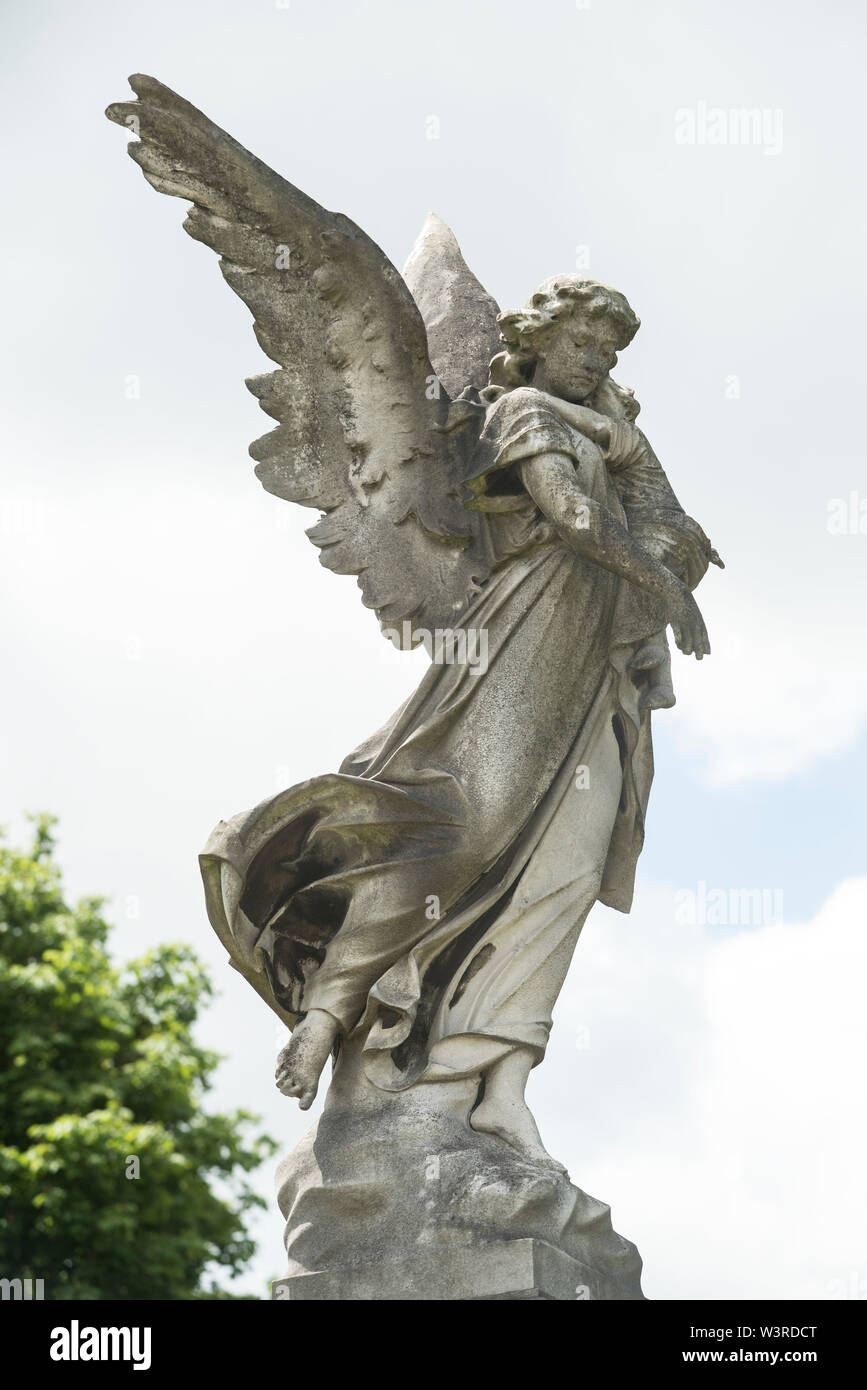 Victorian statue of an angel carrying away a small child - a memorial ...