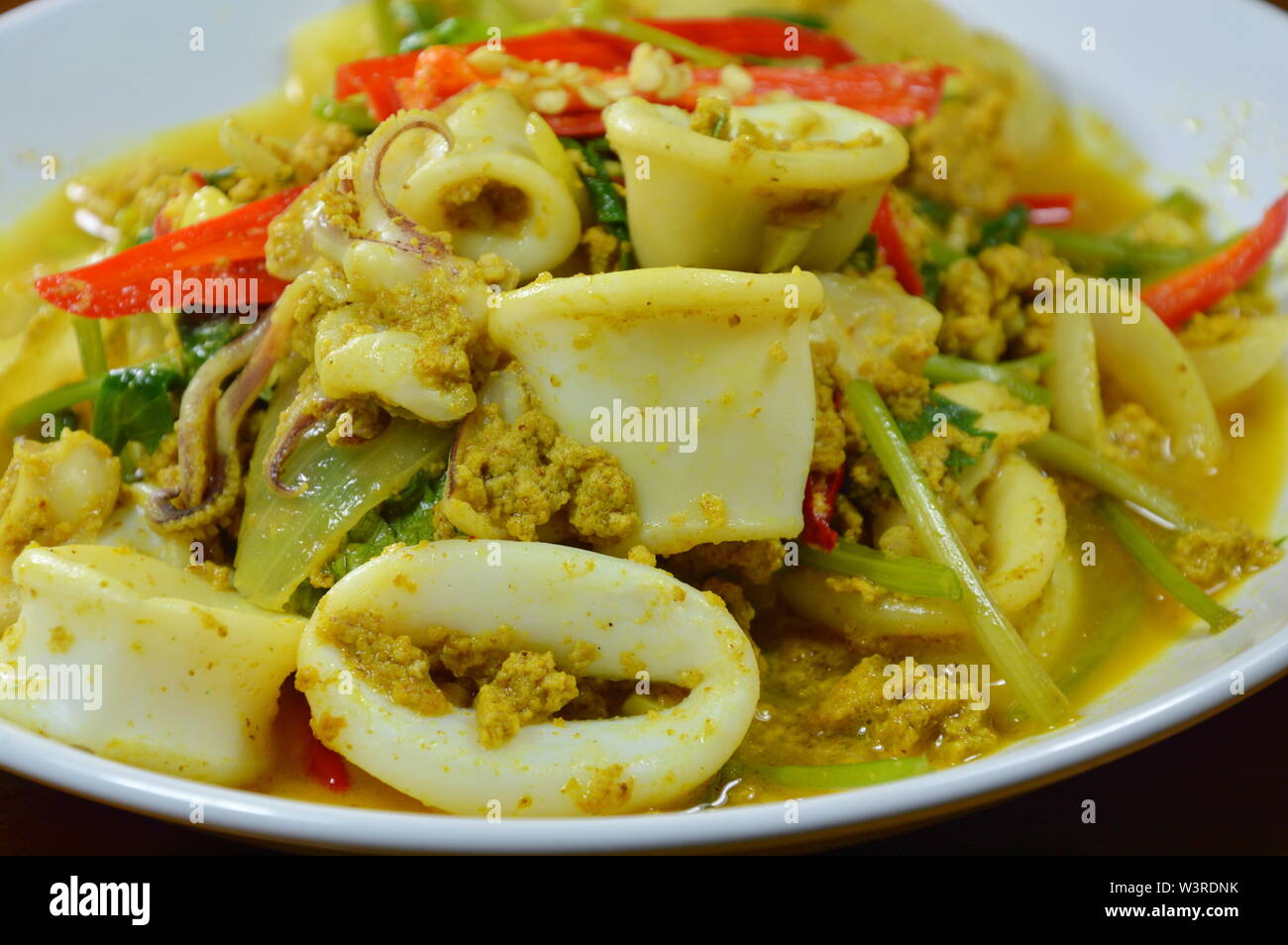stir fried squid with yellow curry on dish Stock Photo - Alamy