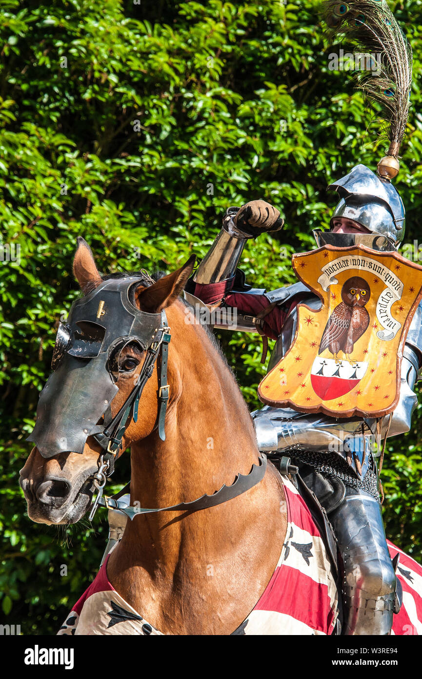 An armoured knight on his bay charger salutes during Joust Week at ...