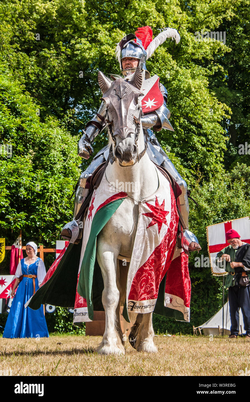 An armoured knight on his charger enters the arena during a Historical ...