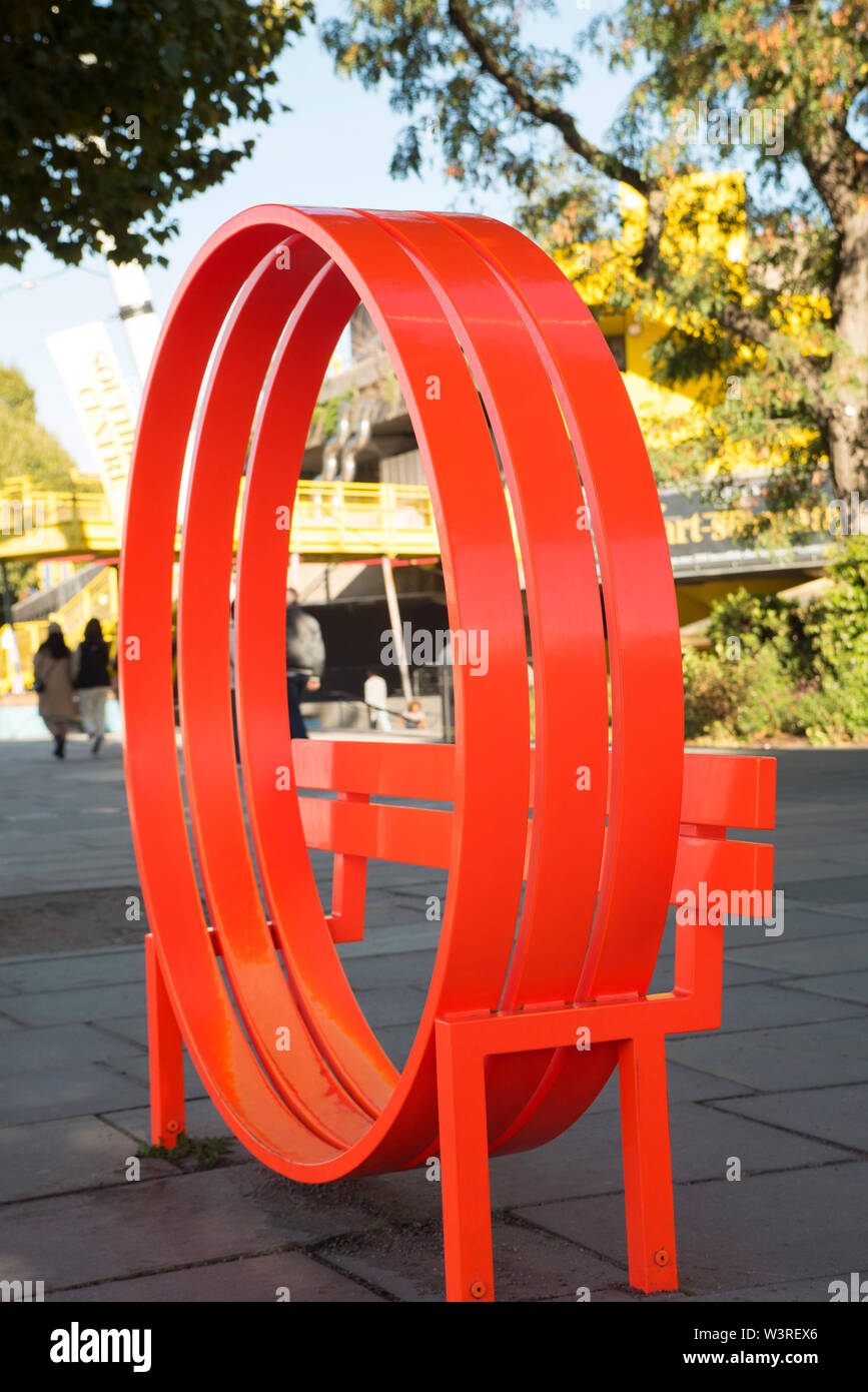 A public bench with a difference. Bright, fluorescent orange circular ...
