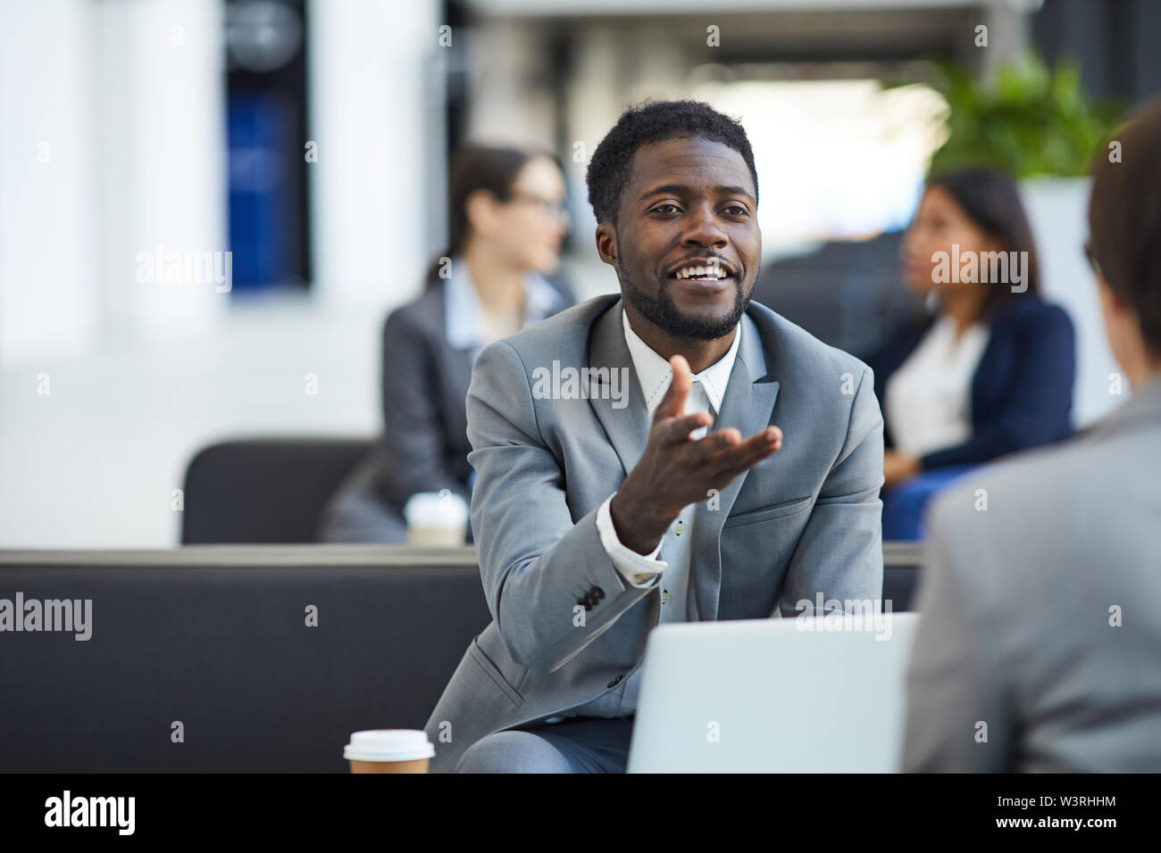 Positive confident handsome young black bearded businessman in gray ...