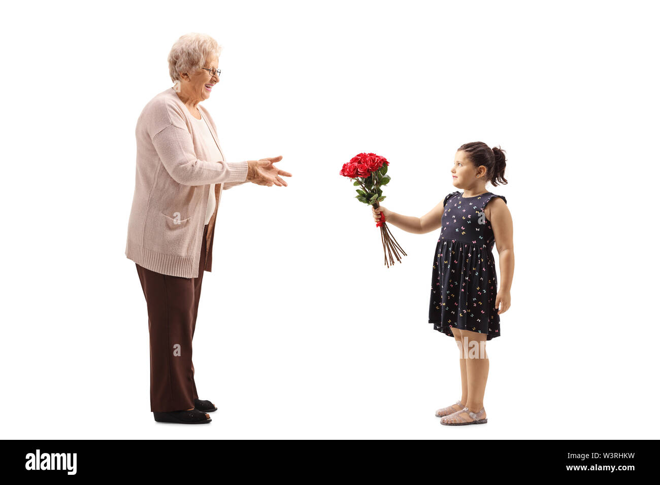 Full length shot of a little girl giving a bunch of red roses to a ...