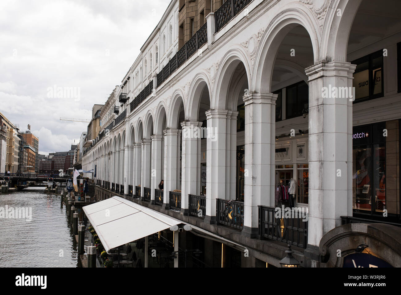 Shops in the Alsterarkaden, a historic shopping arcade by the Alster ...