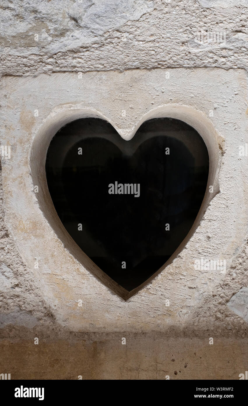 heart shaped window in house wall, dordogne, france Stock Photo - Alamy
