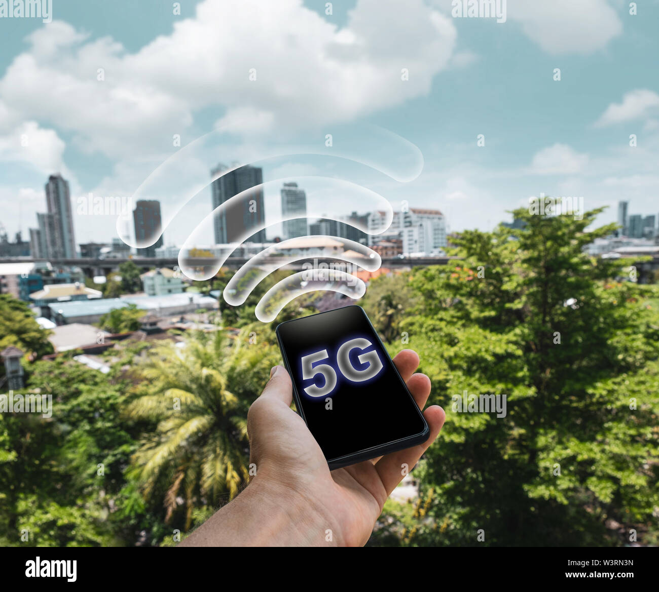 Man holding phone with 5G mobile network logo on screen. Fifth ...