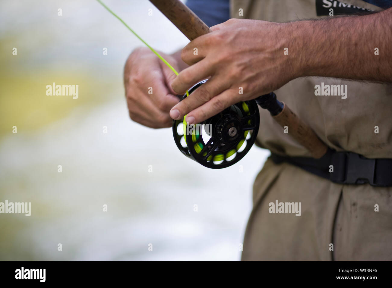 Close-up of man holding fishing rod Stock Photo - Alamy