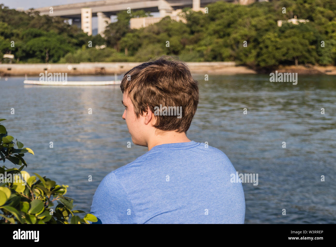 A young boy watching the sea Stock Photo - Alamy