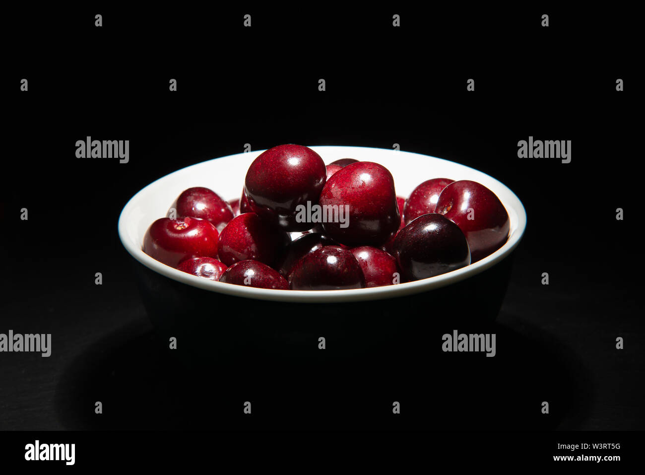 delicious bigarreau cherry in black background Stock Photo - Alamy