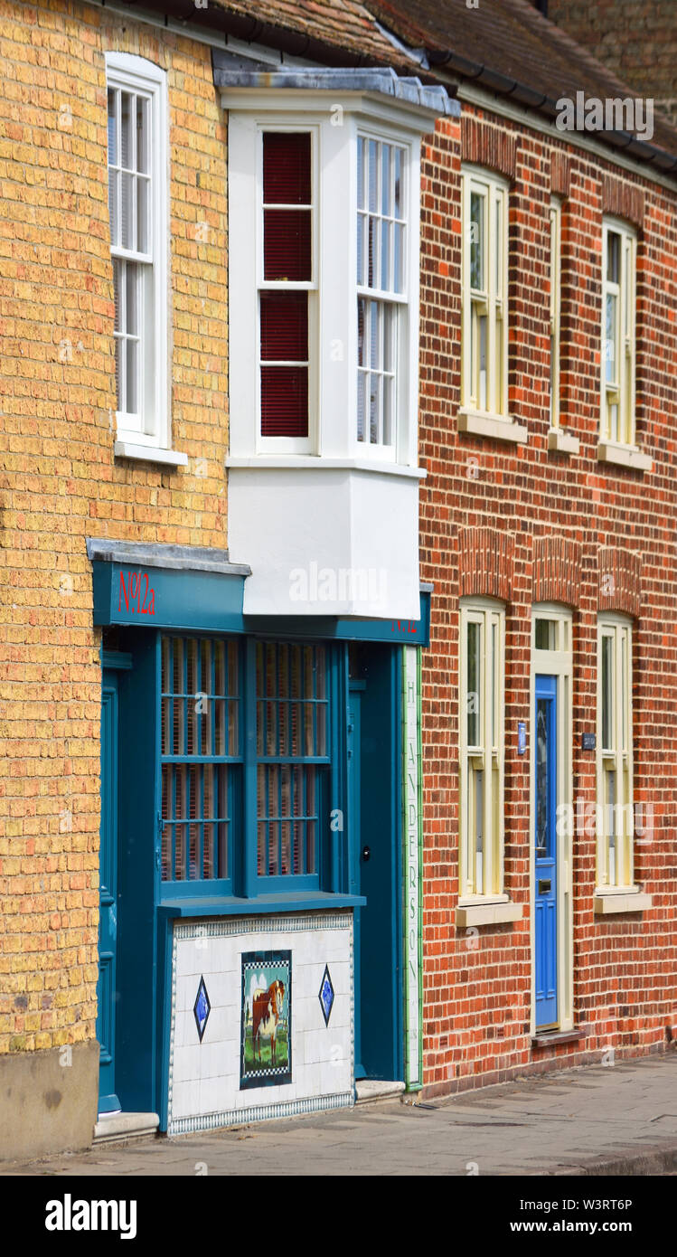 Terrace Housing and Colourful Tiled Butchers Shop Front Stock Photo - Alamy