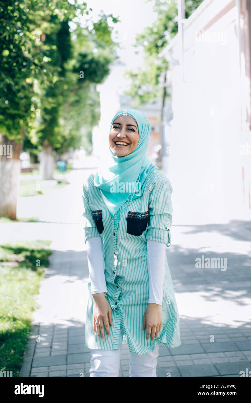 Portrait of pretty young muslim woman on a street Stock Photo - Alamy