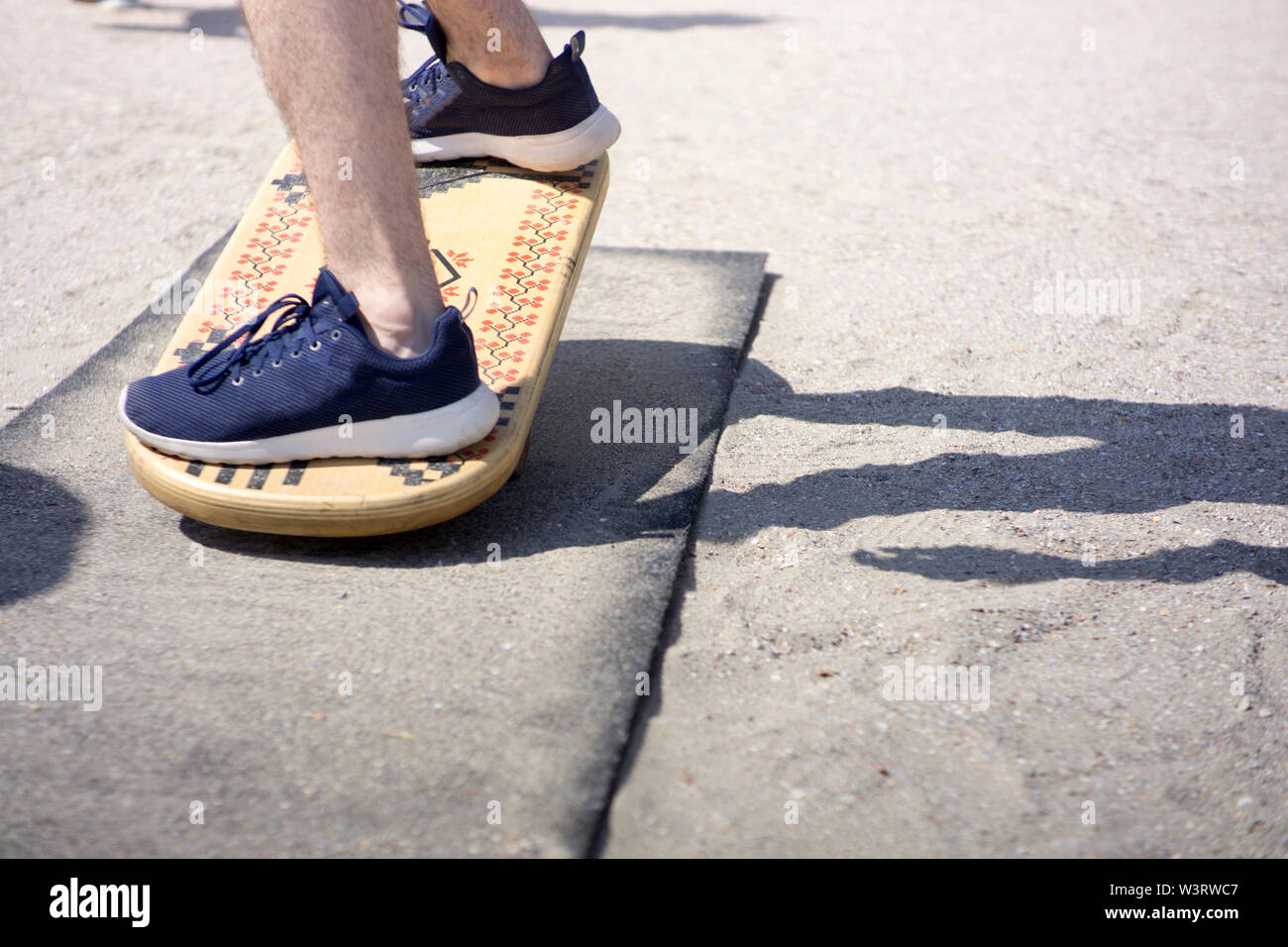 Balancing on a balance board in sunny weather at the beach Stock Photo ...