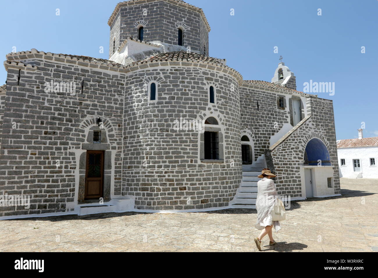 A woman walks by Profitis Ilias (Prophet Elijah) monastery in Hydra ...