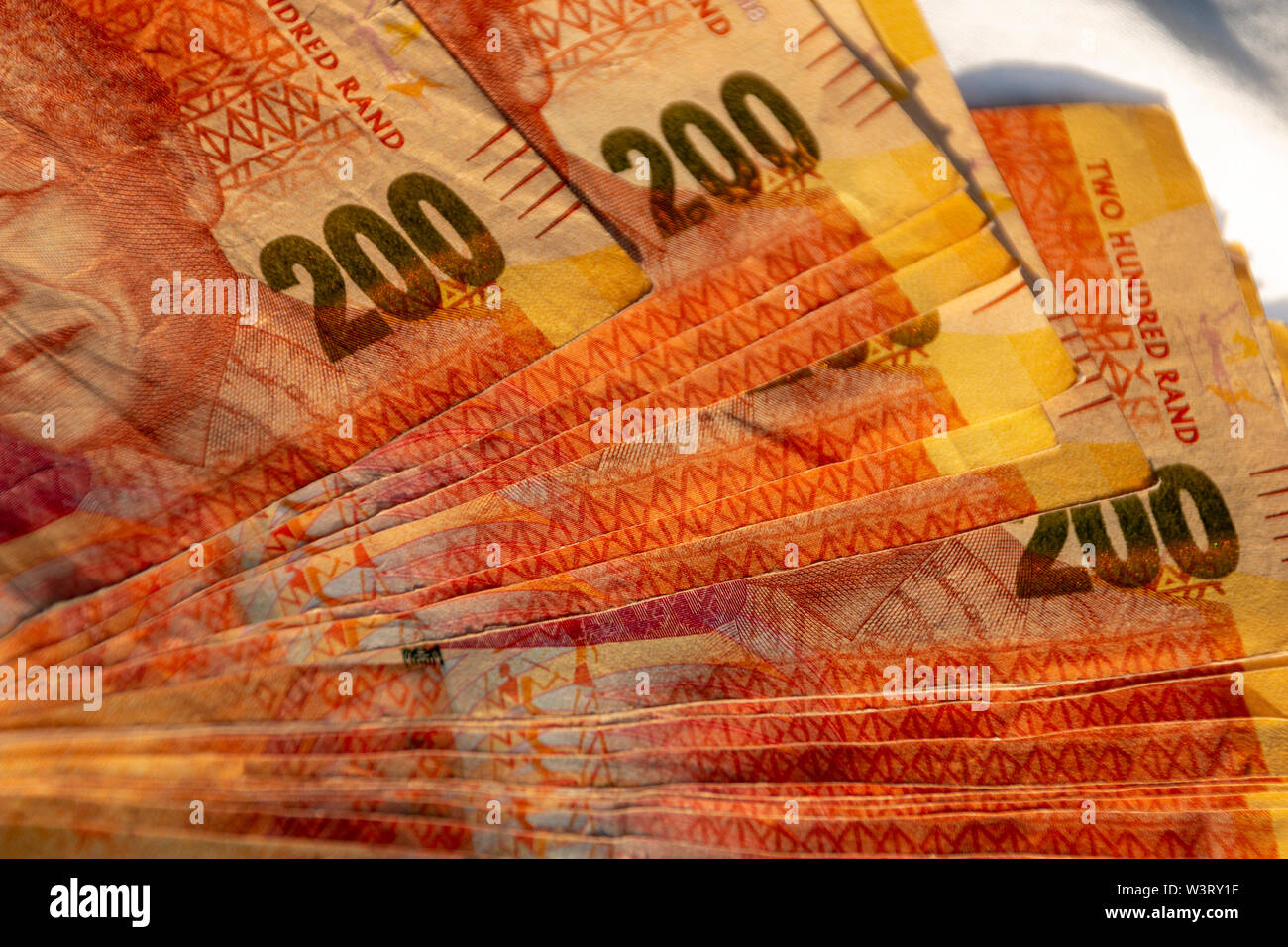 A close up view of two hundred south african notes in a pile on a ...