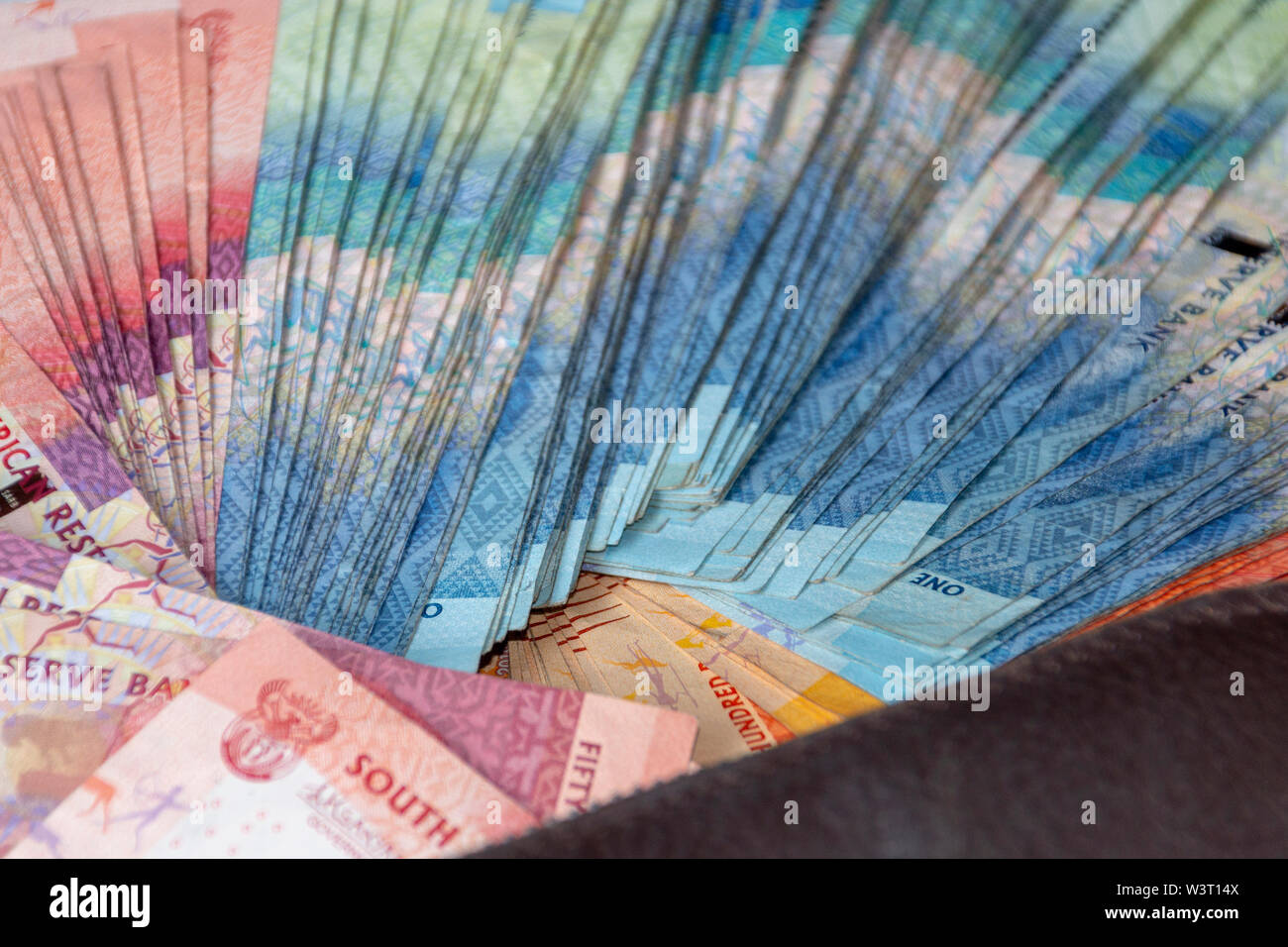 A close up view of pile of two hundred, one hundred and fifty rand ...