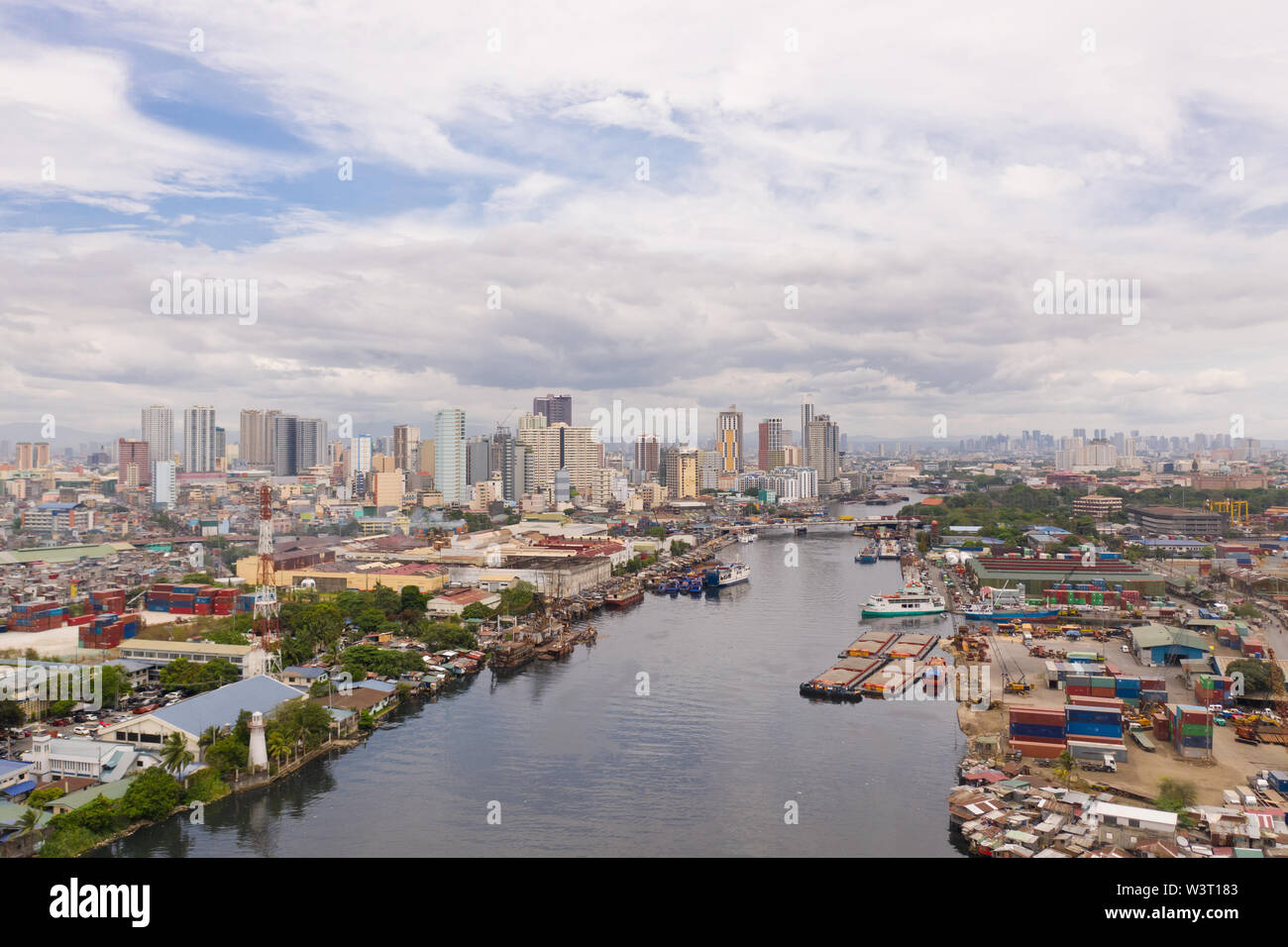 The urban landscape of Manila, with slums and skyscrapers. Sea port and ...