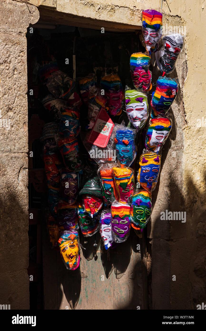 Knitted colourful masks on display in doorway of an artisan shop in ...