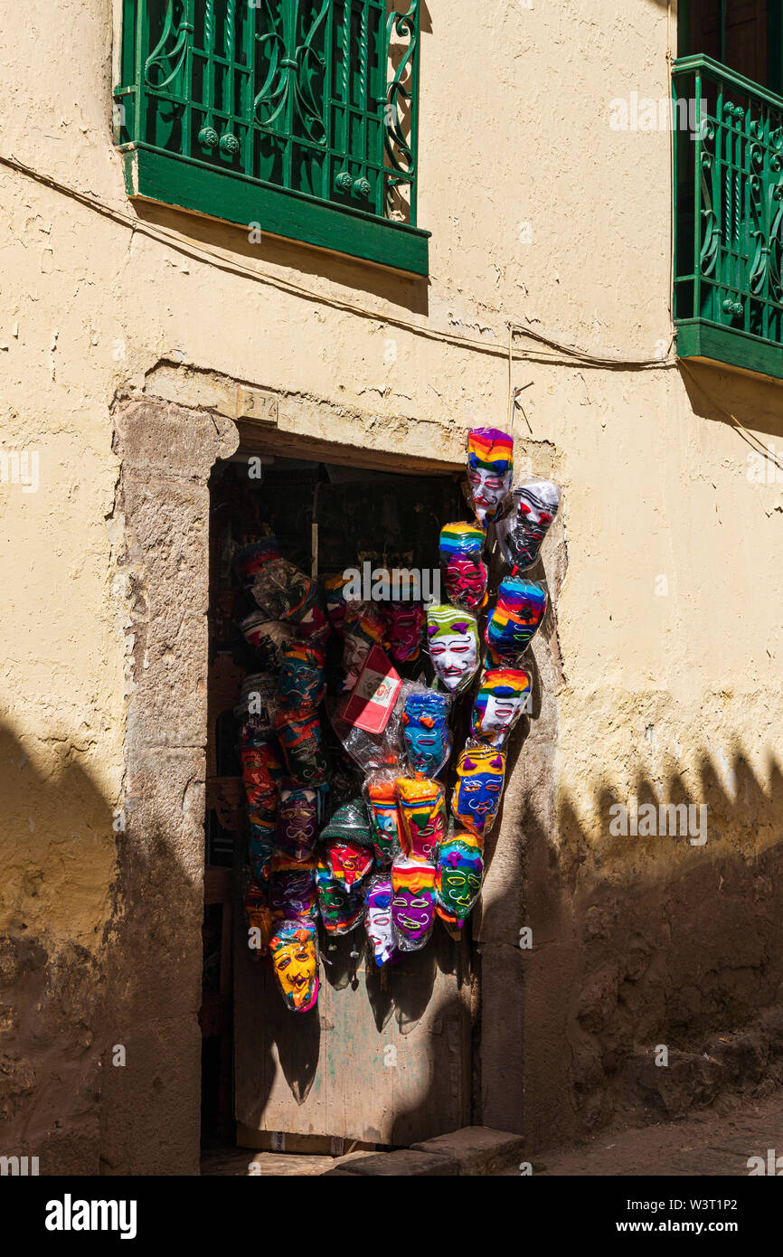 Knitted colourful masks on display in doorway of an artisan shop in ...
