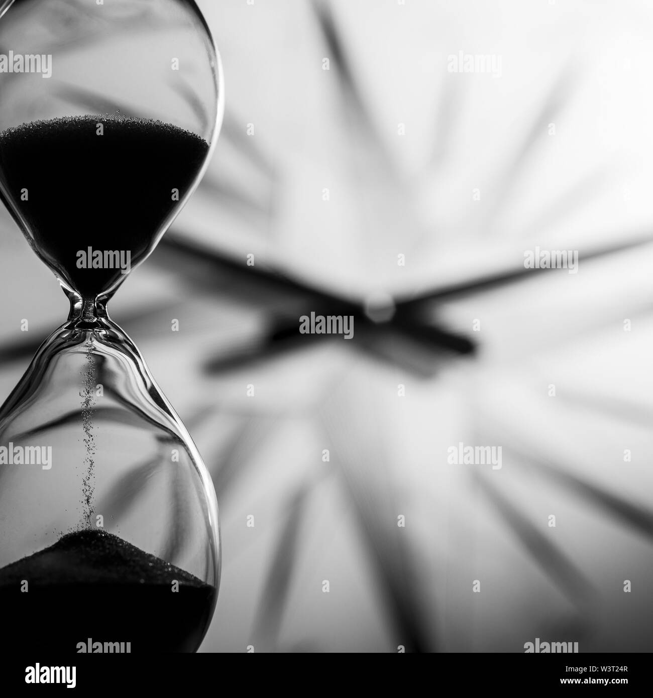 close-up of sand grains of an hourglass mark the expiration of time ...