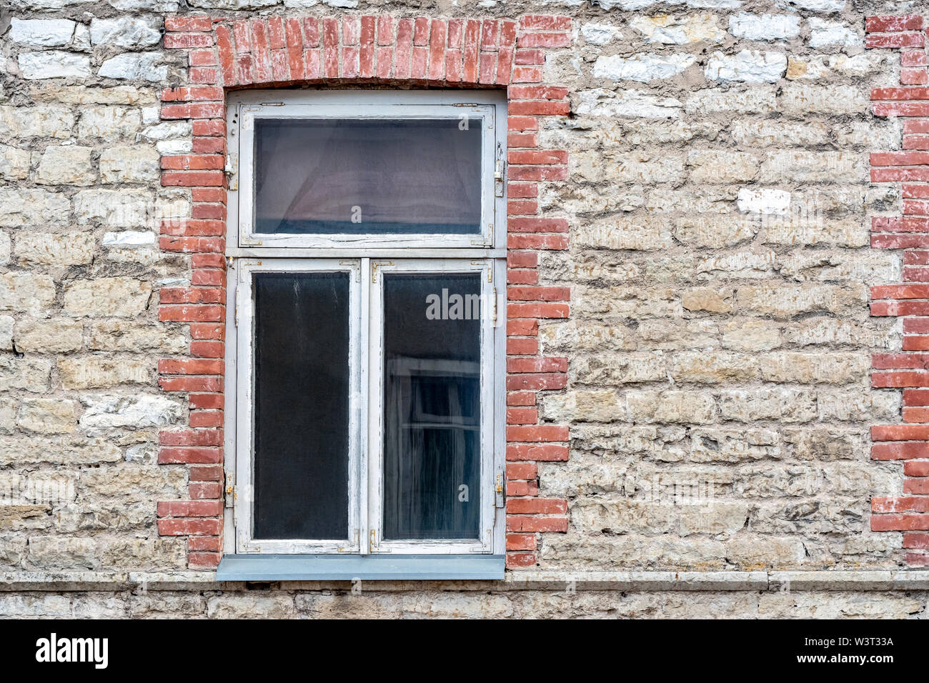 Rectangular window with a white wooden frame on the background of the ...
