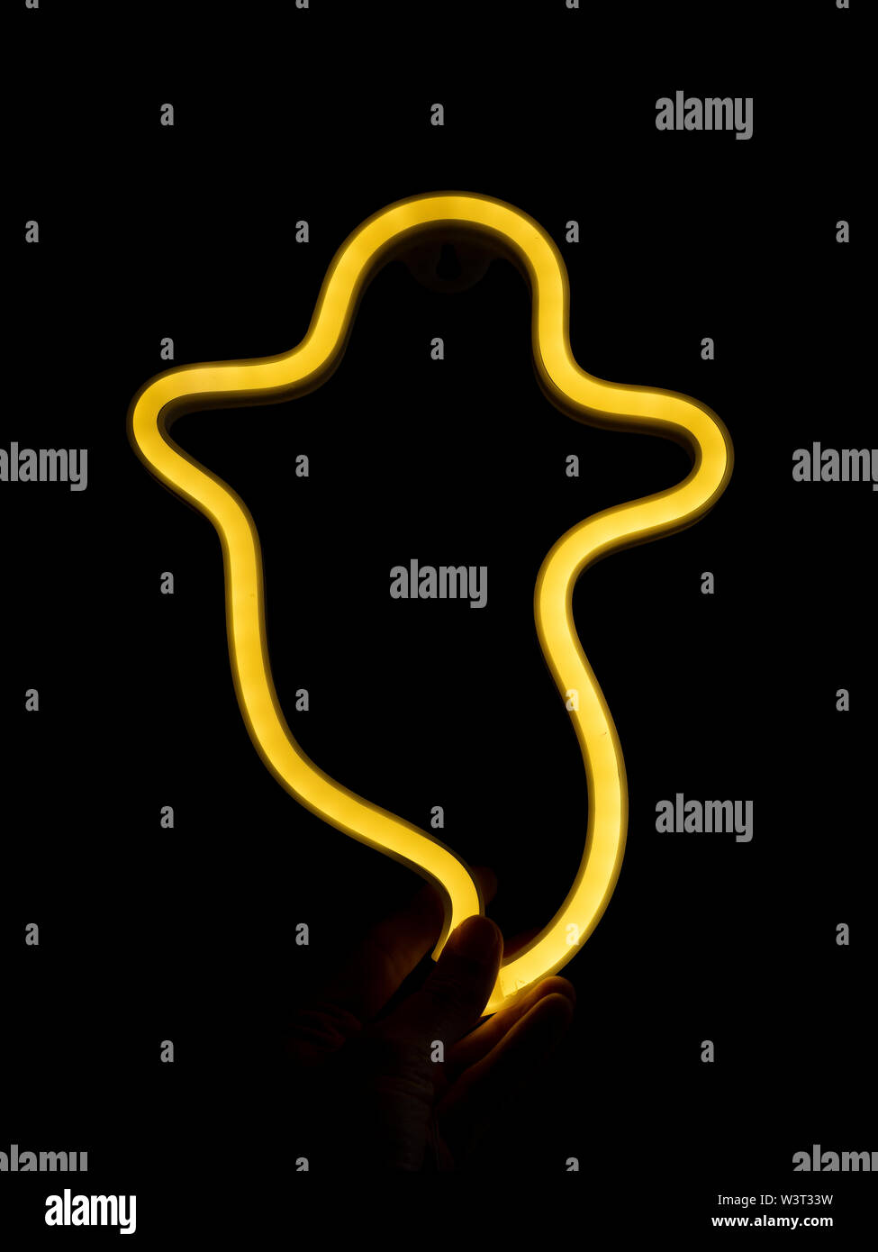 Ghost neon on black background fastened by hand Stock Photo - Alamy